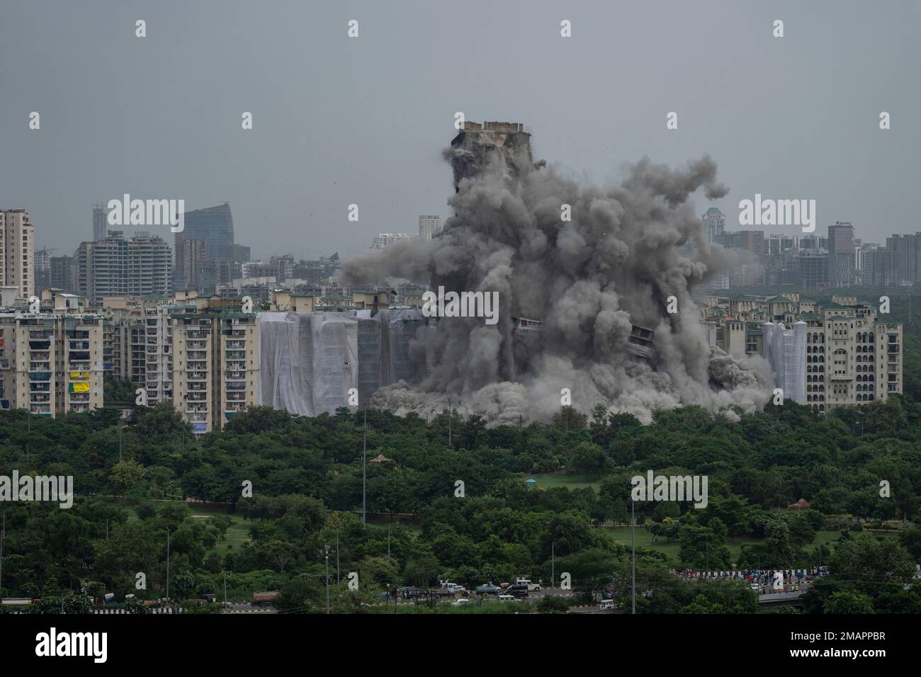 Cloud of dust rises as twin high-rise apartment towers are razed to ...