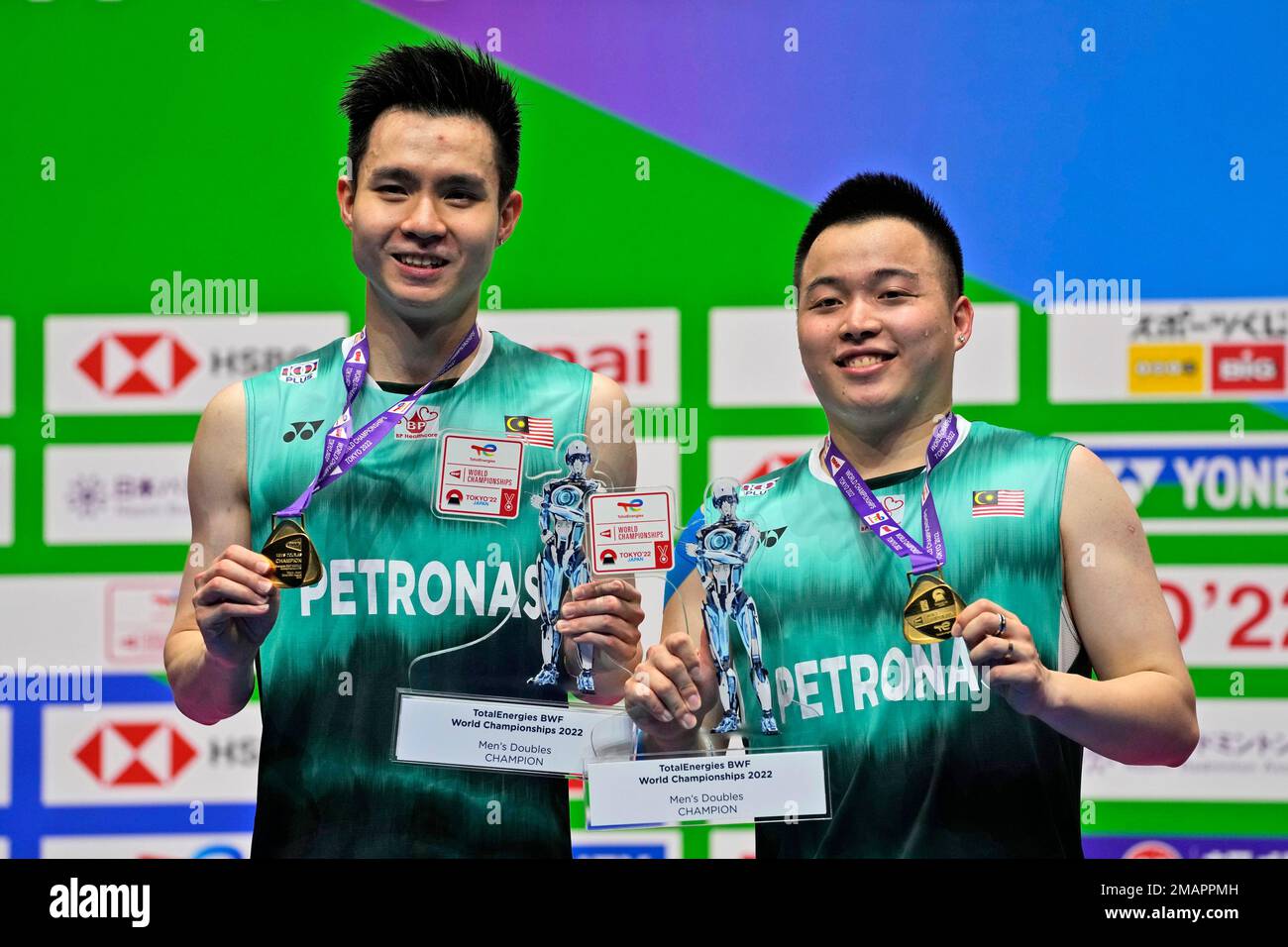 Malaysia's Aaron Chia, right, and Soh Wooi Yik celebrate with their gold medals after winning ...