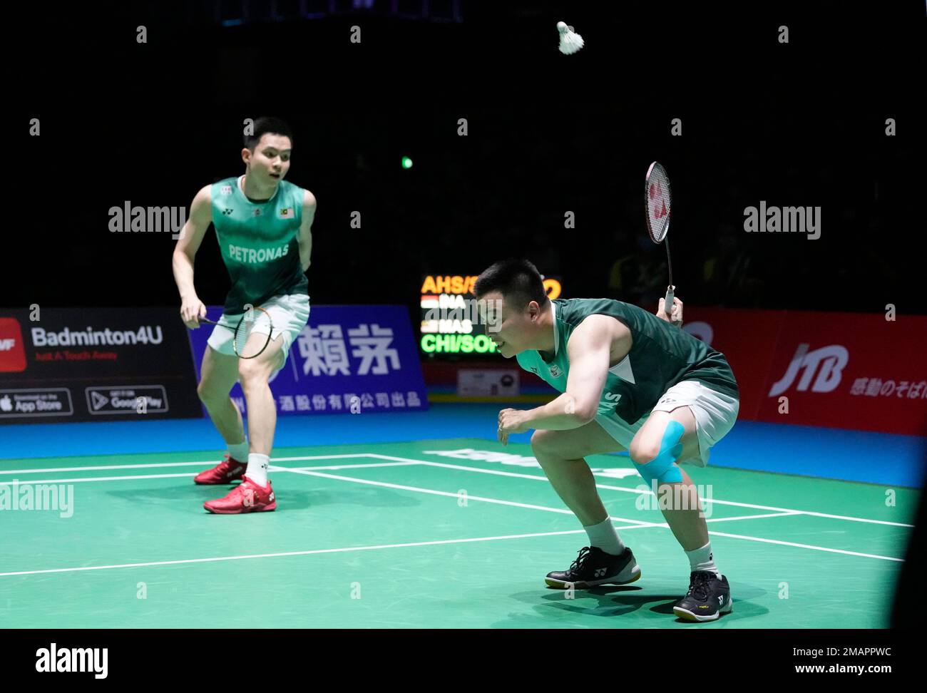 Malaysia's Aaron Chia, right, attempts to return the shuttlecock from ...
