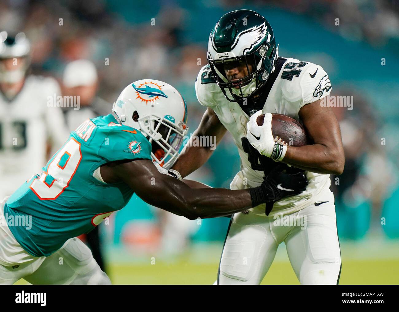 Miami Dolphins linebacker Sam Eguavoen (49) attempts to tackle ...