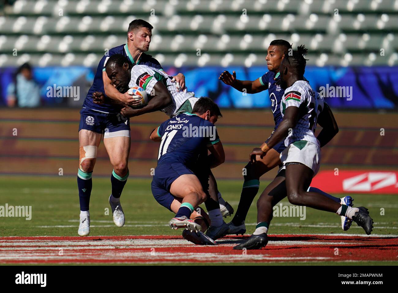 Kenya's Billy Odhiambo,holds the ball as he is tackled by Scotland's ...