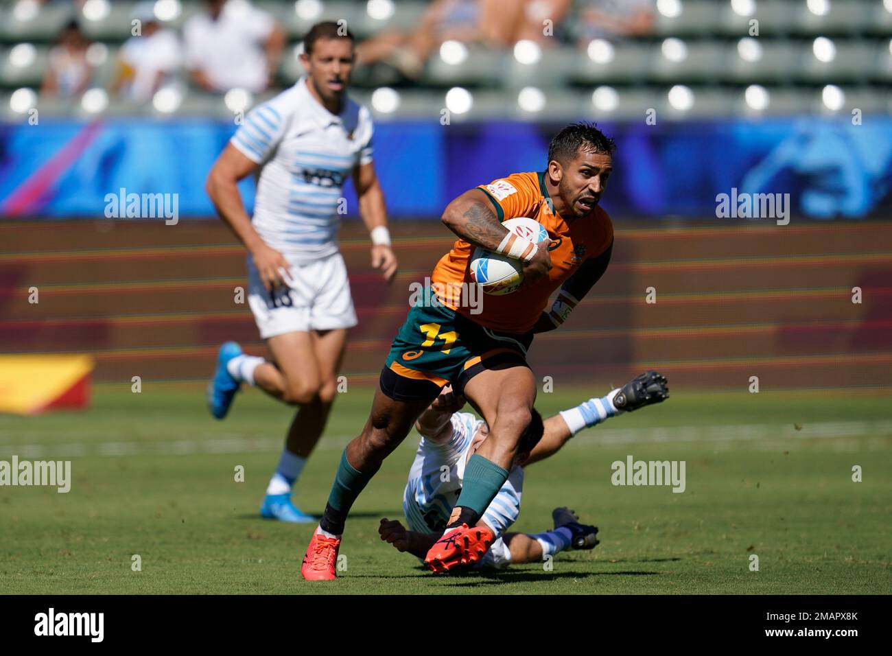 Australia's Maurice Longbottom, gets past the tackle of Argentina's ...