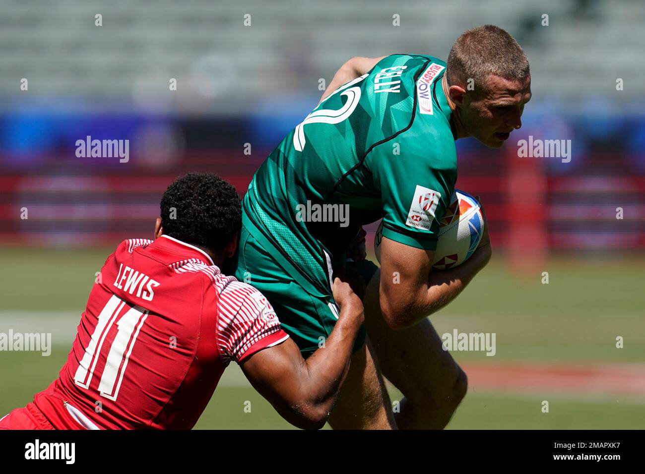 Ireland's Ed Kelly, right, is tackled by Wales' Lloyd Lewis during ...
