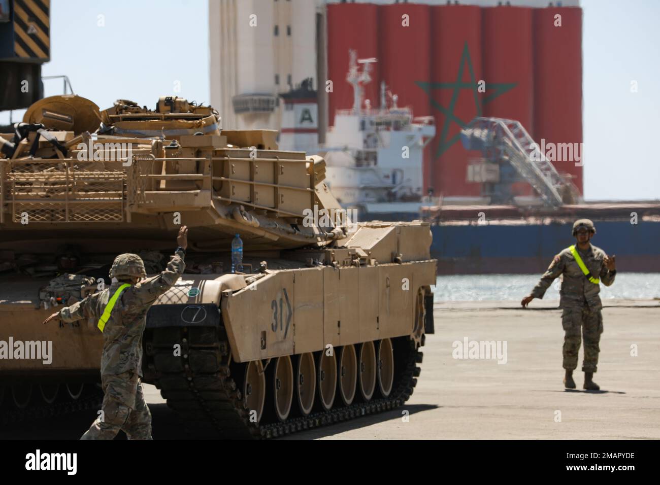 U.S. Army soldiers direct an M1A3 Abrams Tank from the 1-12 Cavalry ...