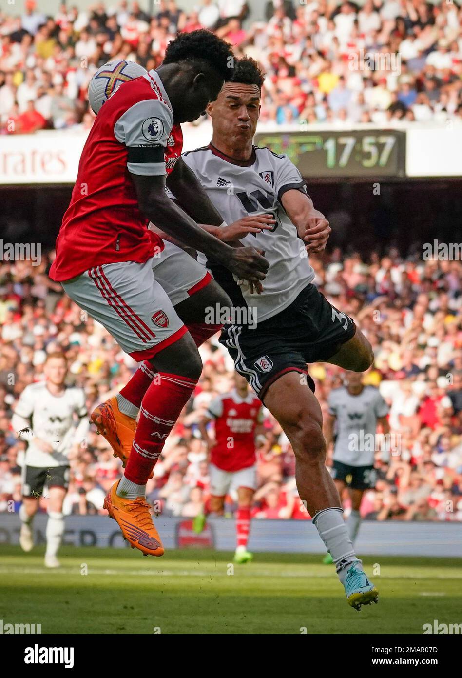 Arsenal's Bukayo Saka, left, challenges for the ball with Fulham's Antonee Robinson during the ...