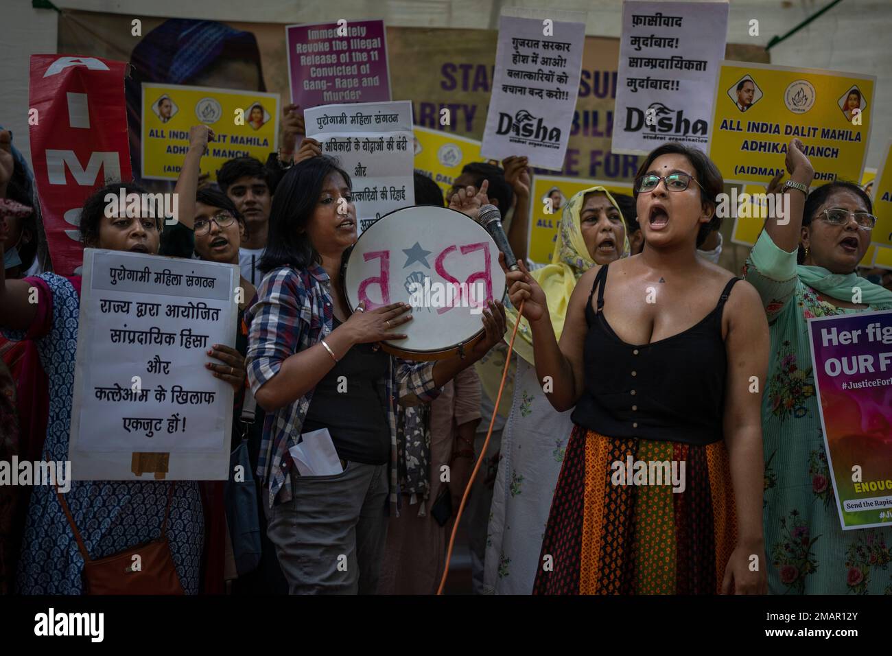 Activists shout slogans during a protest against remission of sentence ...