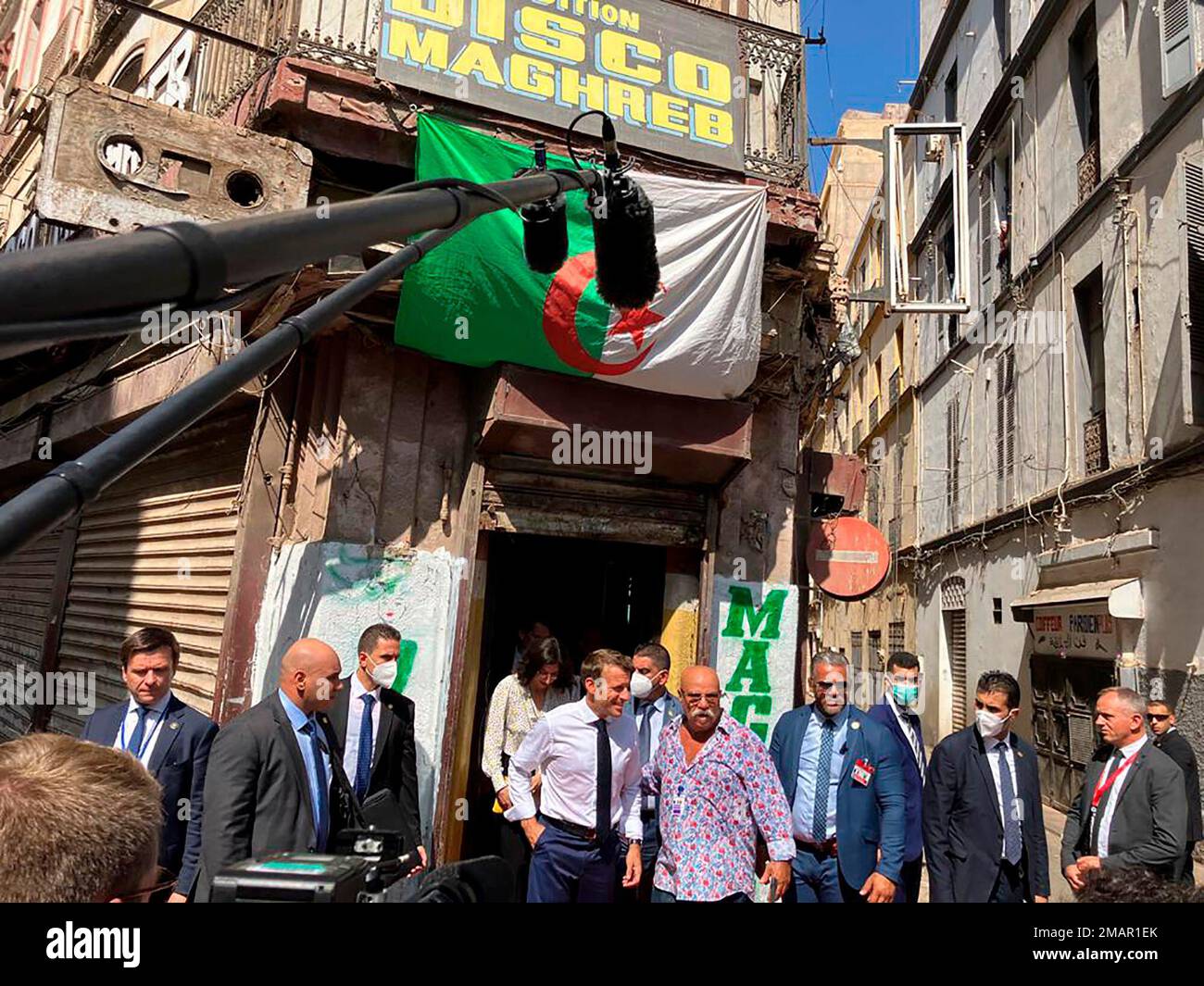 French President Emmanuel Macron, center, leaves the Disco Maghreb, an ...