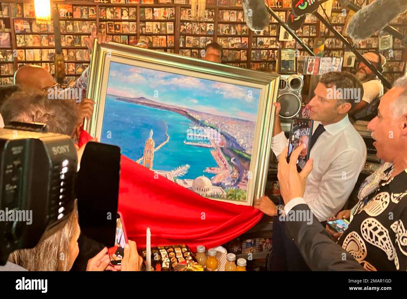French President Emmanuel Macron, second right, unveils a painting ...