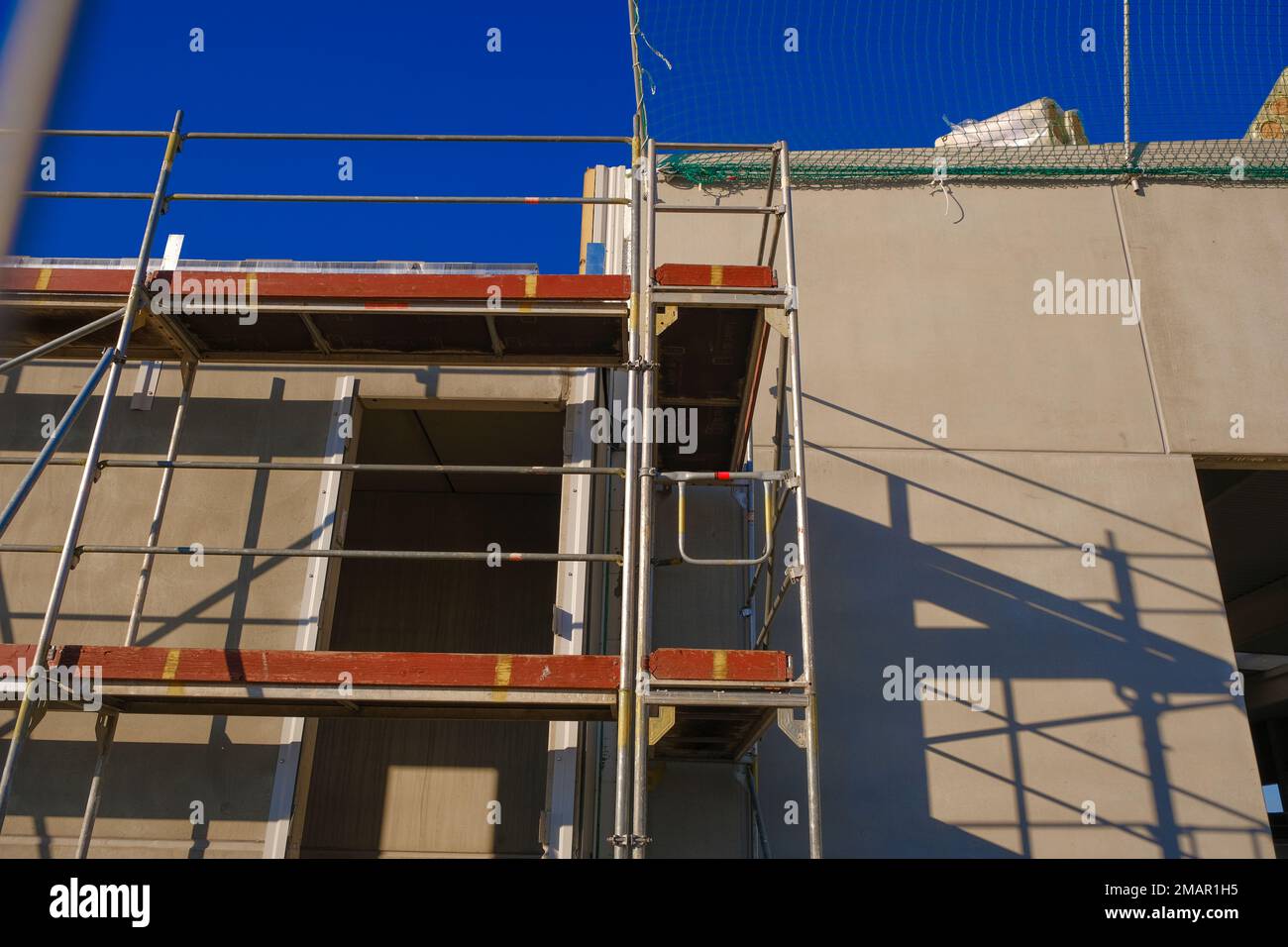 house in scaffolding on blue sky background.walls of the house in ...