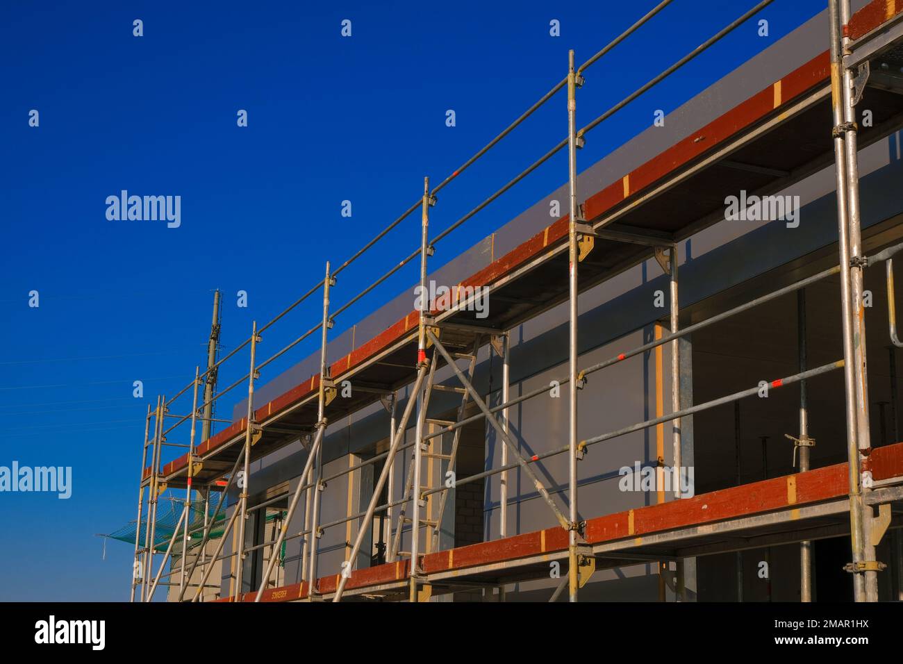 Scaffolding and construction.New house in scaffolding on blue sky ...