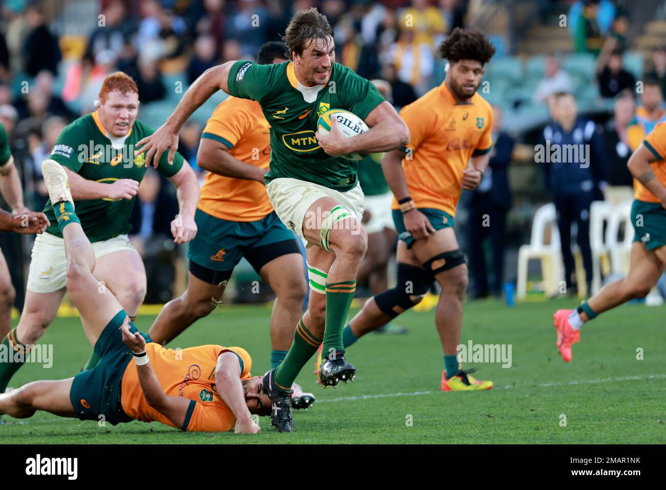 South Africa's Eben Etzebeth, center, breaks a tackle from Australia's ...