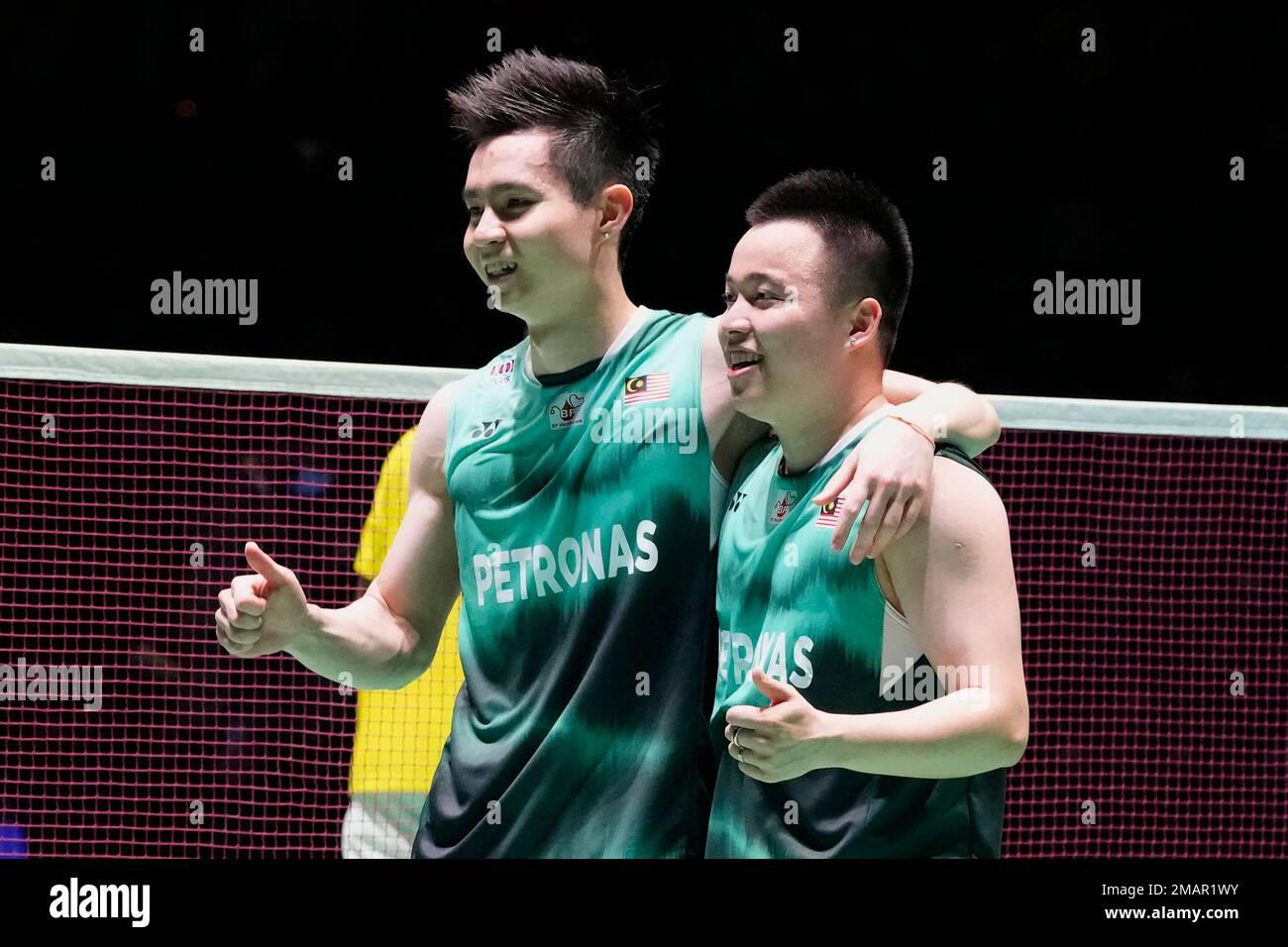 Malaysia's Aaron Chia, right, and Soh Wooi Yik celebrate after winning a badminton game of the ...