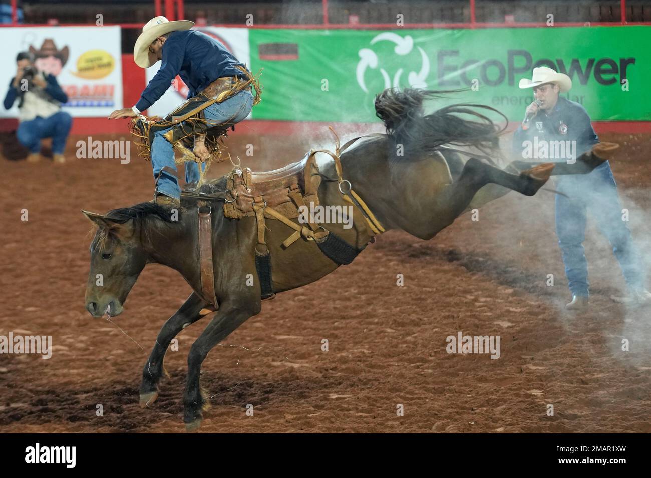 A cowboy is ejected from a horse during horse riding competition at the ...