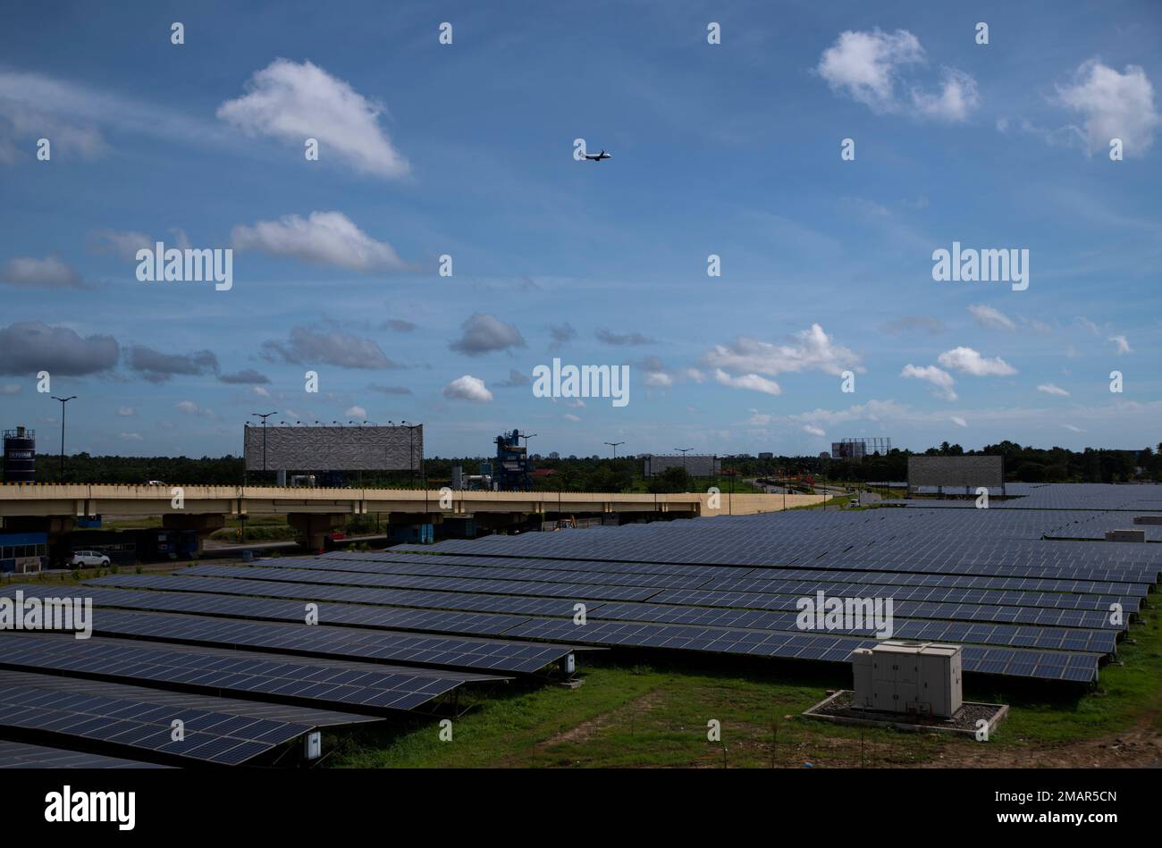 An airplane takes off over solar panels at the Cochin International ...