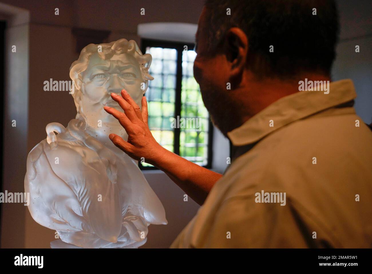 Chinese artist Ai Weiwei touches one of his glass sculpture at the San Giorgio church in Venice ...