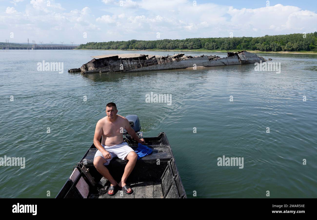 Fisherman Ivica Skodric navigates by a wreckage of a WWII German ...