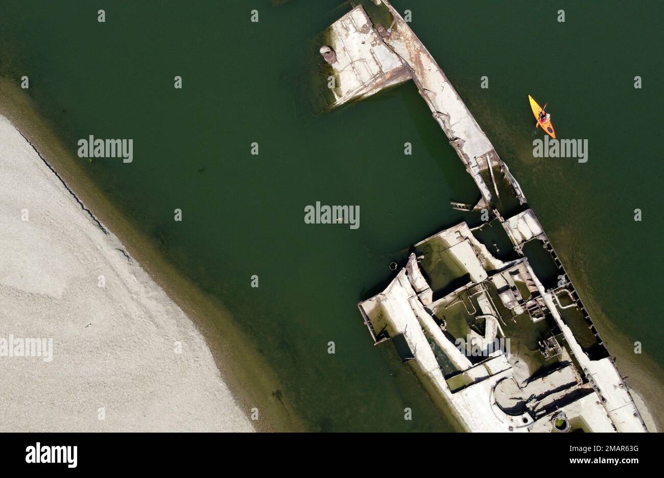 Kayaker Aleksandar Bzdusok paddles by the reckage of a WWII German ...