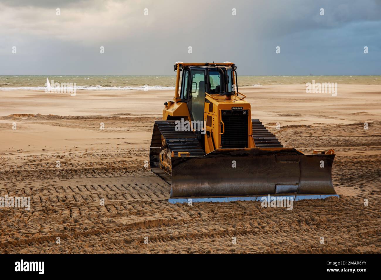Bulldozer prepares the sea beach for the season Stock Photo - Alamy