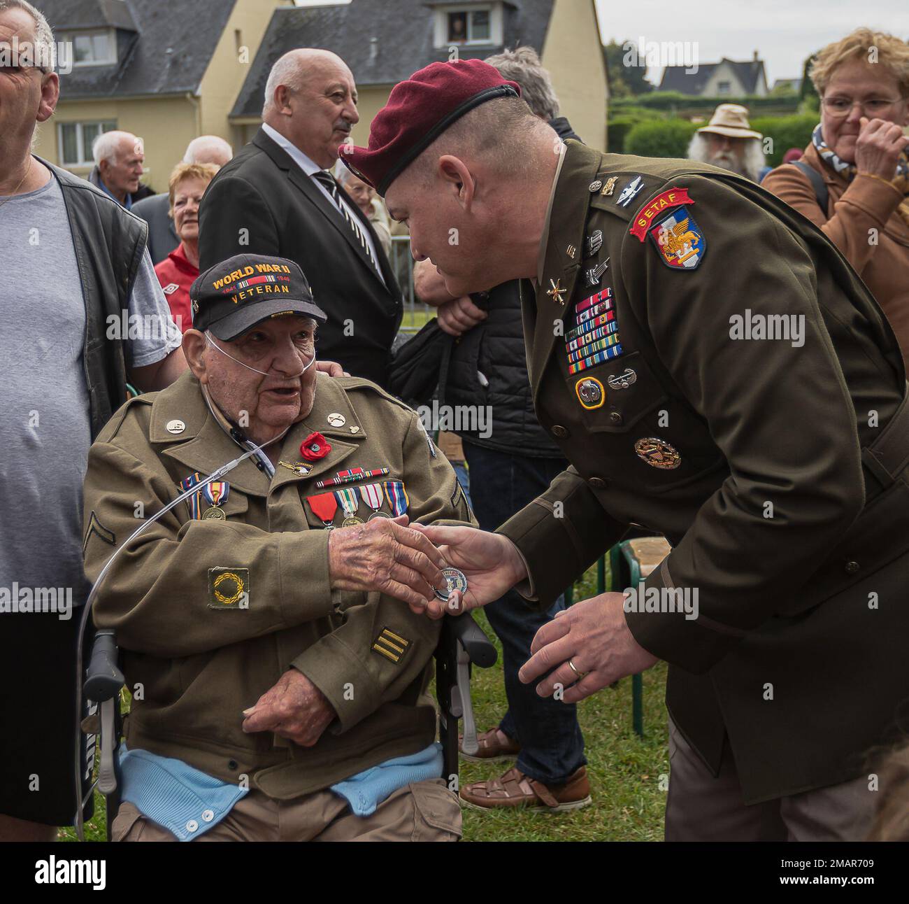 American World War II veteran, George Merz, receives a coin from U.S ...