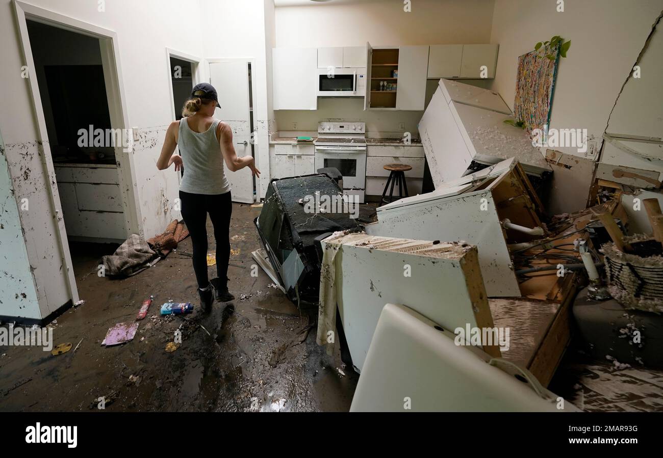 Brooke Conley looks for personal items to salvage at her flooded ...