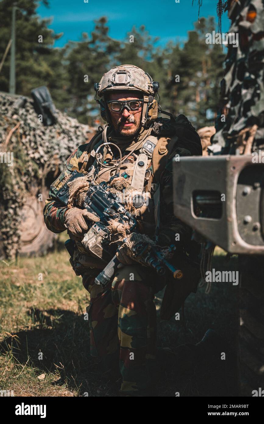 A Belgian Armed Forces soldier assigned to ISTAR COY takes cover behind ...