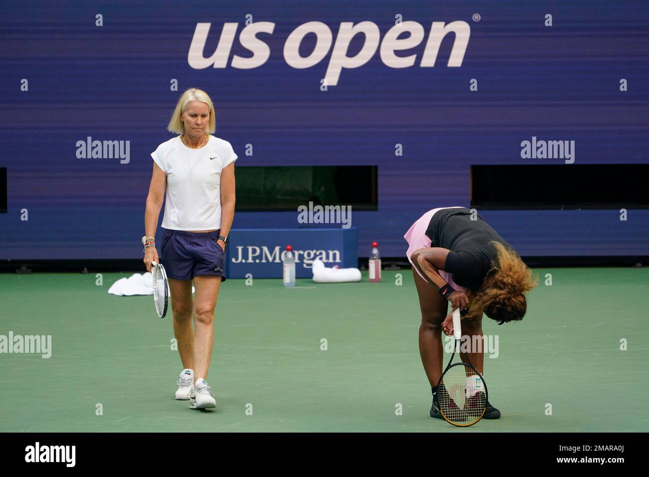 Serena Williams, right, leans on her racket while practicing at Arthur ...