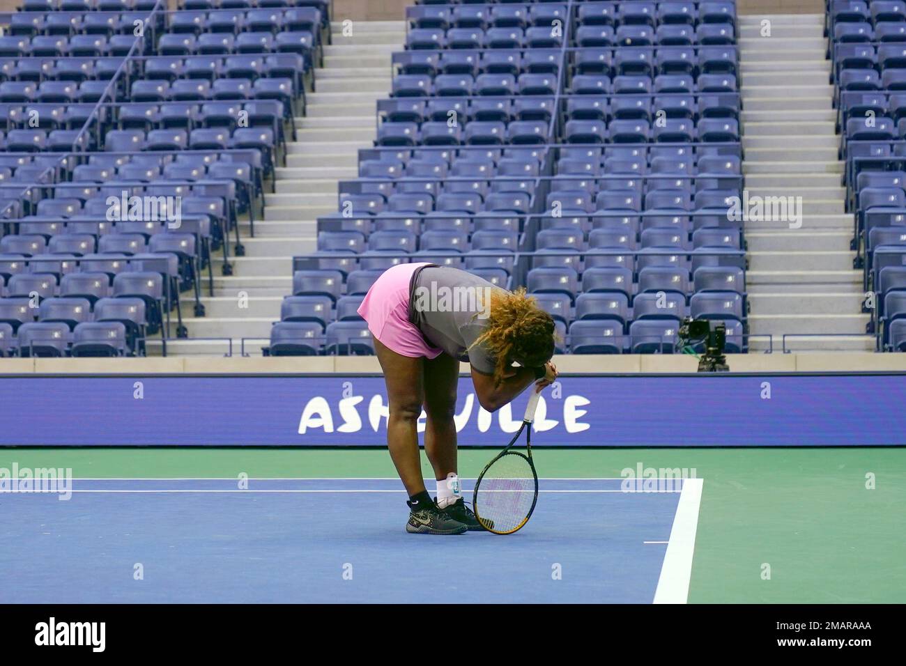 Serena Williams rests on the racket while practicing at Arthur Ashe ...