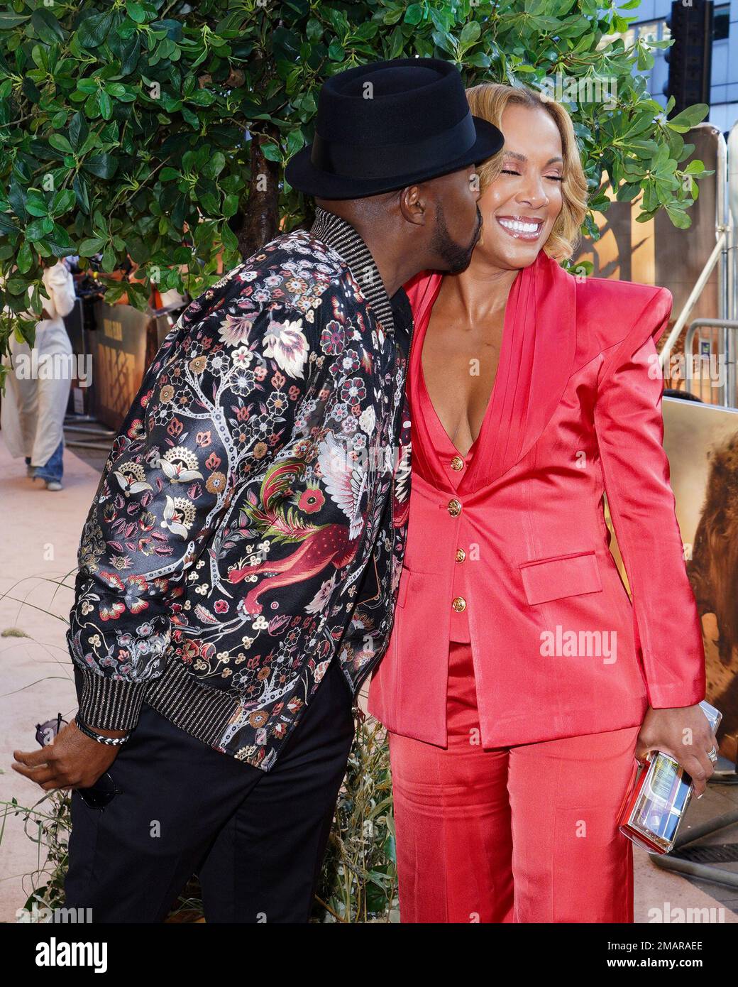 Heather Packer, left, and Will Packer pose for photographers upon ...