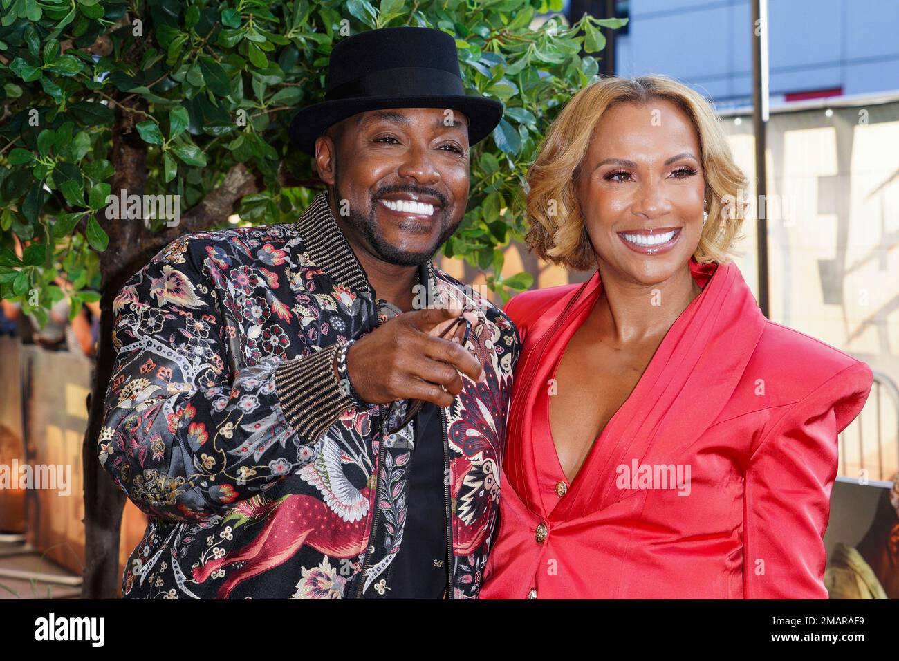 Heather Packer, left, and Will Packer pose for photographers upon ...
