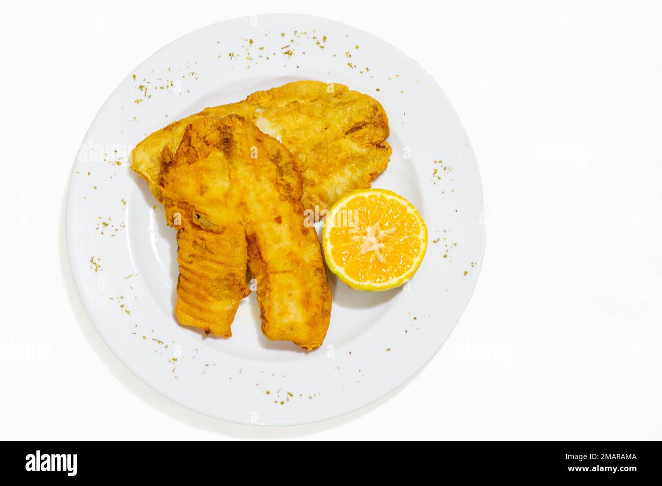 fried fish fillet on a plate on a white background Stock Photo - Alamy