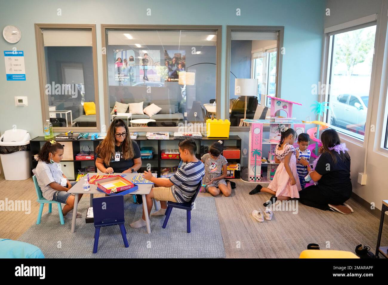 Mentors play games with kids at a Friends of the Children office ...