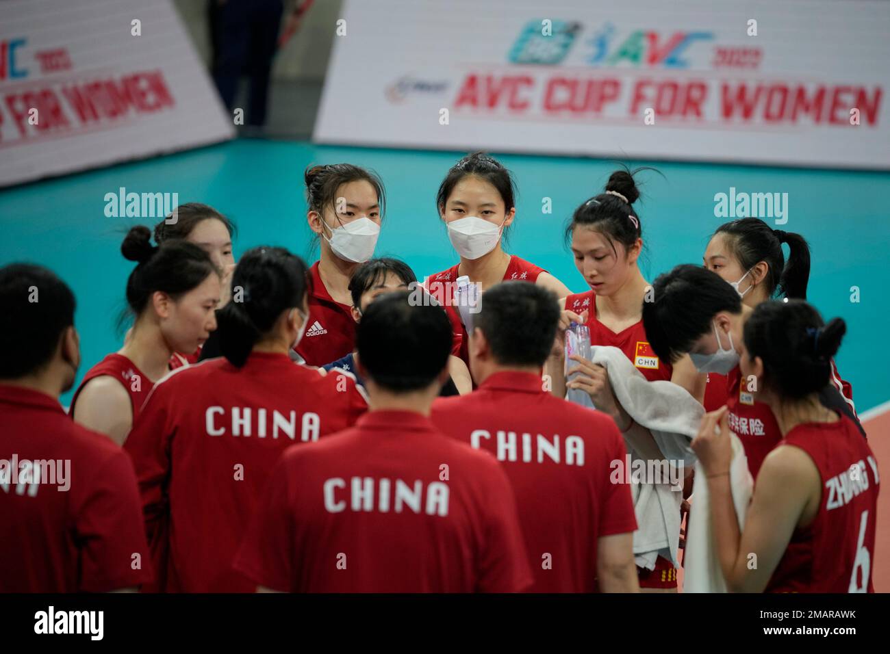 Chinese players, some wearing face masks, gather during their ...