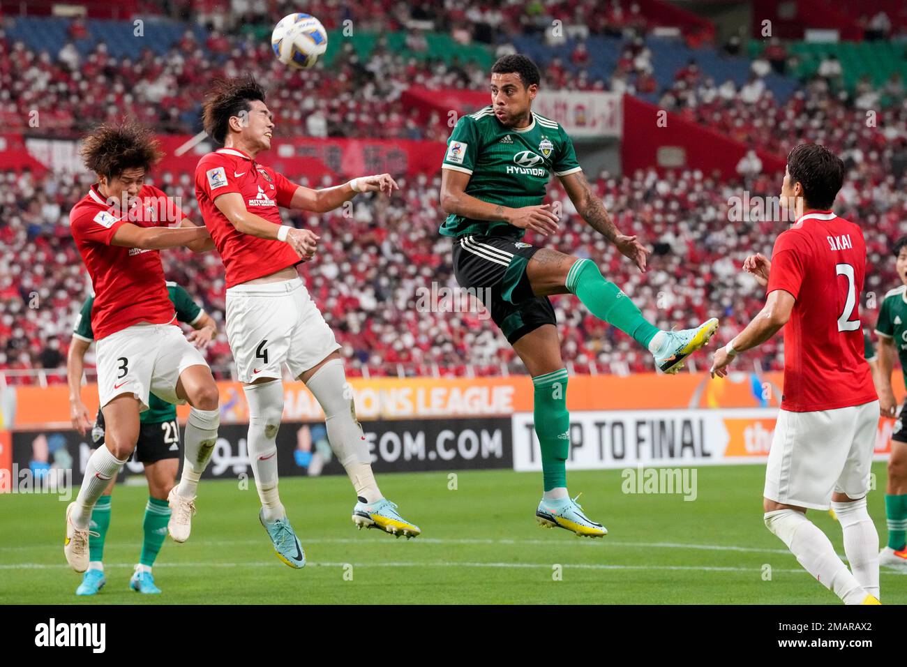 South Korea's Jeonbuk Hyundai Motors' Gustavo, second right, heads the ...