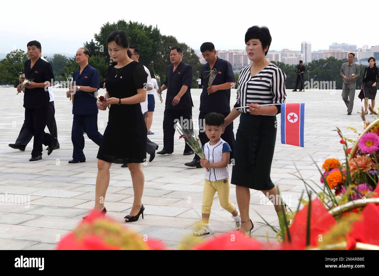 Pyongyang citizens visit the statues of their late leaders Kim Il Sung ...