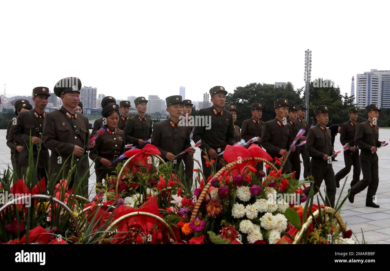 Korean People's Army (KPA) service personnel visit the statues of their ...