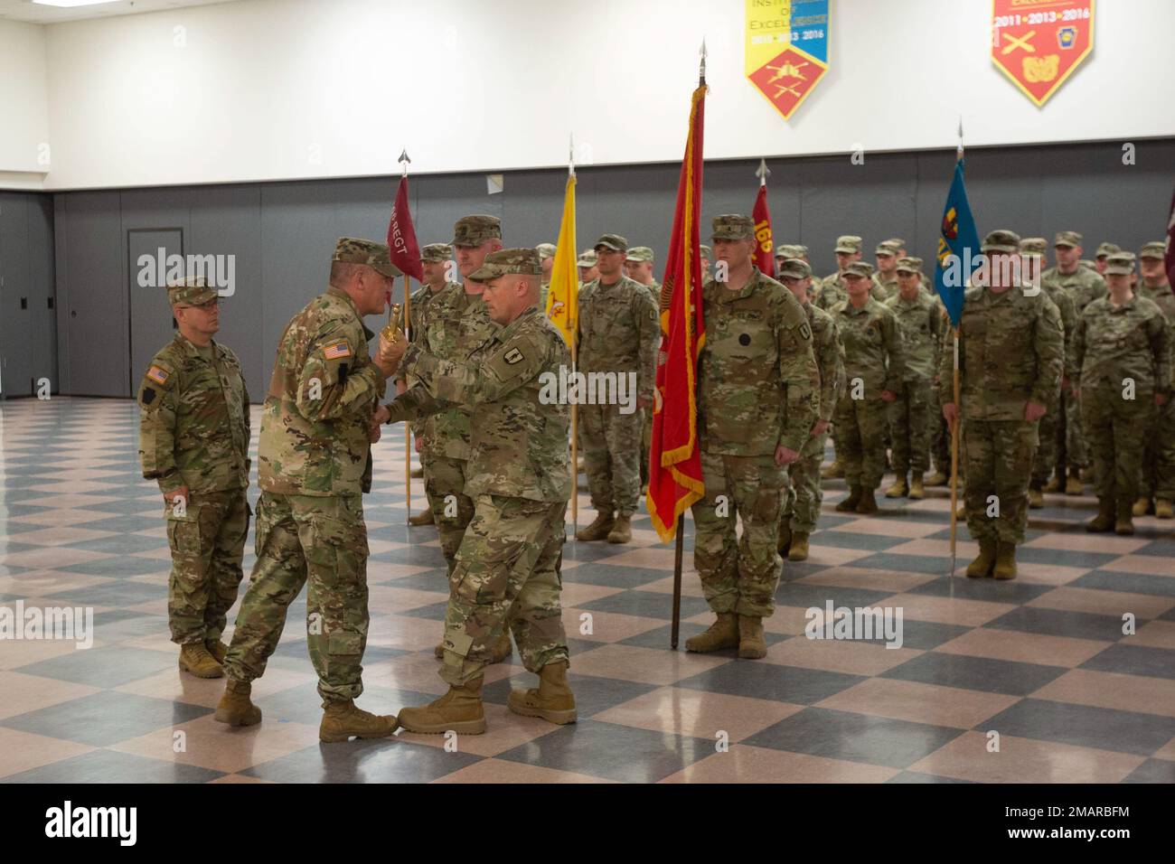 U.S. Army Command Sgt. Maj. Eric French passes a sword during a change ...