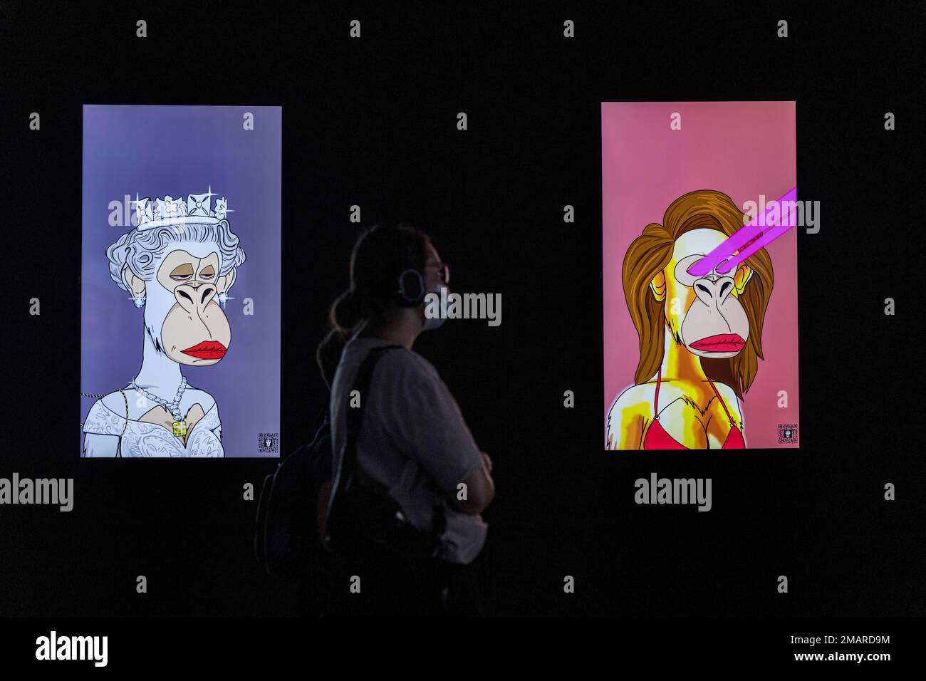 A visitor looks at NFT (non-fungible tokens - blockchain tokens) works ...