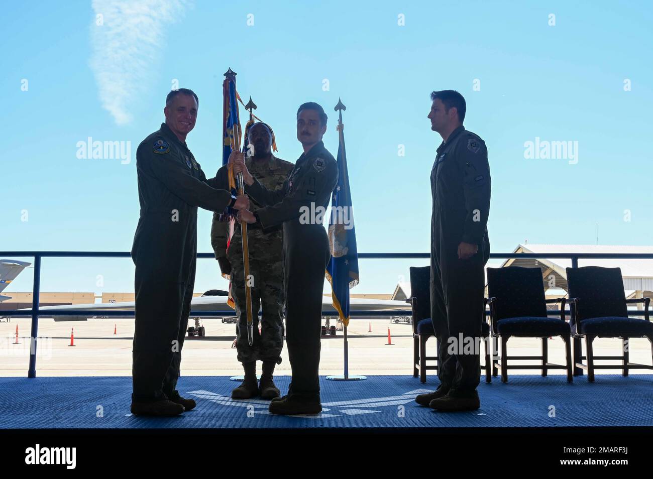 U.S. Air Force Lt. Col. Christopher Conant, outgoing 393rd Bomb Squadron commander, passes the ...