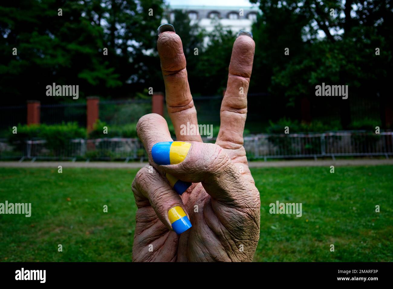 A statue of a hand with finger nails painted in Ukraine's national ...