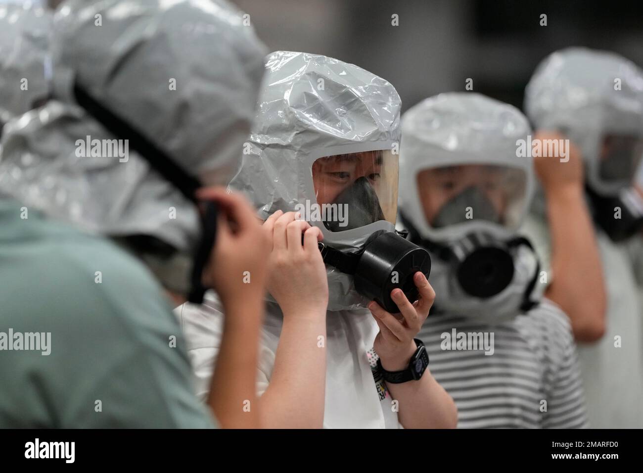 Participants check their gas masks during an anti-terror and anti ...