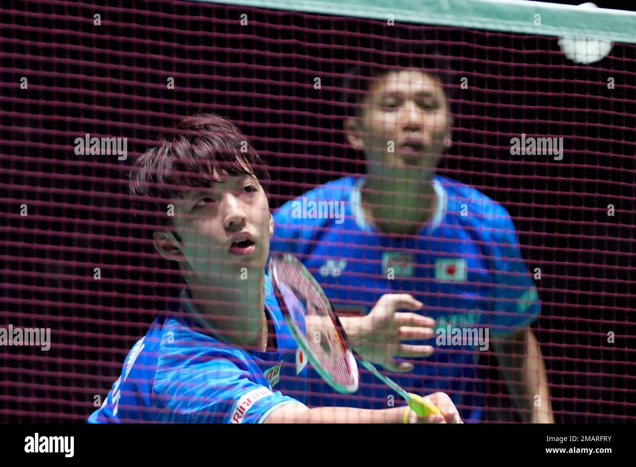 Hiroki Okamura of Japan, with Masayuki Onodera, plays a return during a ...