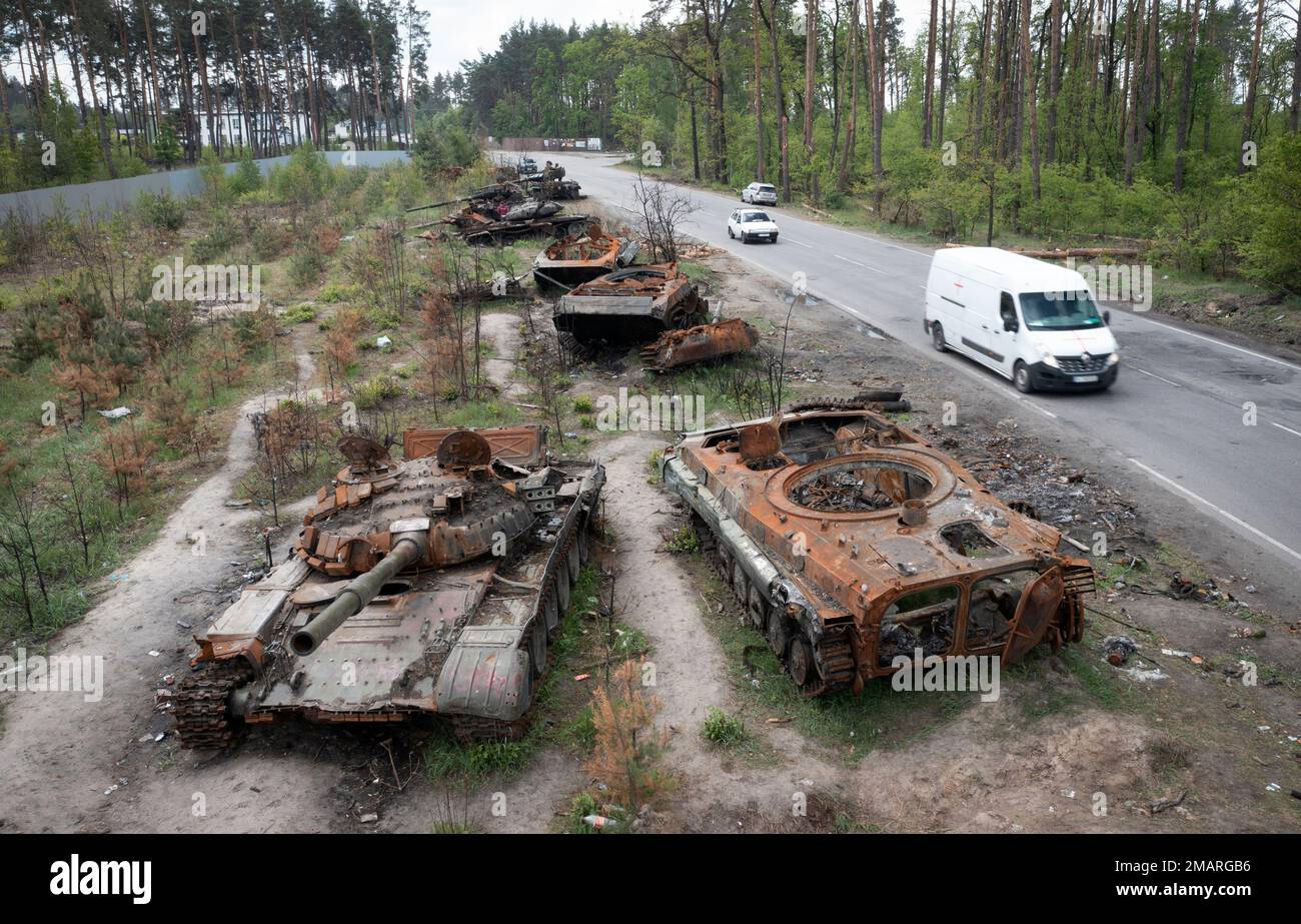 FILE - Cars pass by destroyed Russian tanks in a recent battle against ...