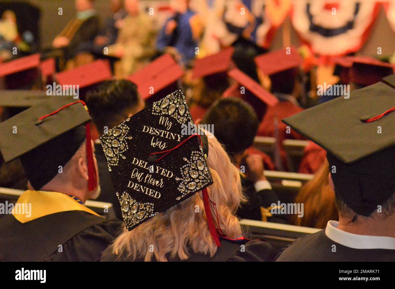 A special decorated graduation cap reading “My destiny was delayed, but ...