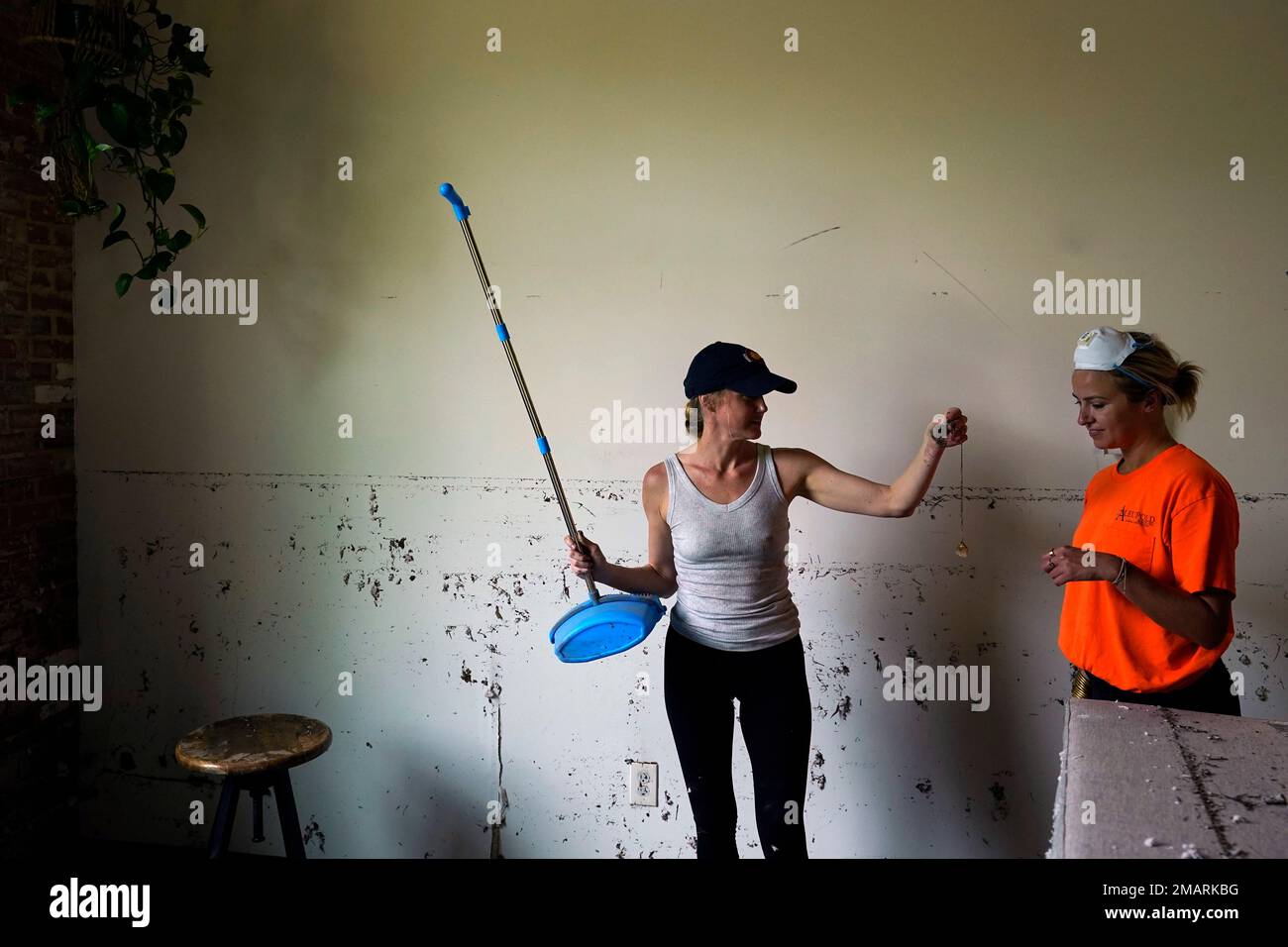 With the high water line on the wall behind, Brooke Conley, left, shows ...