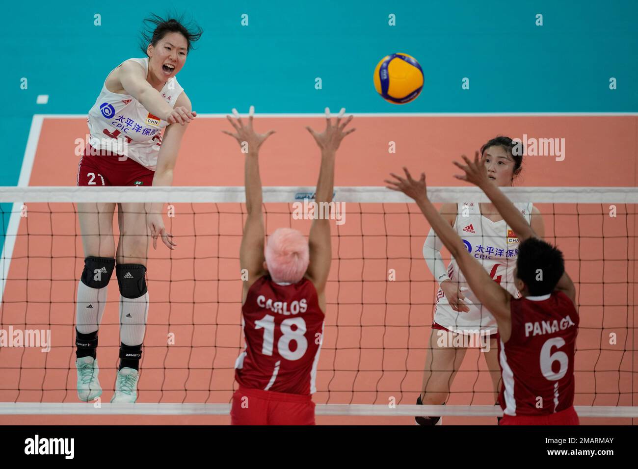 China's Zhou Yetong hits the ball against Philippine players during their preliminary match at ...