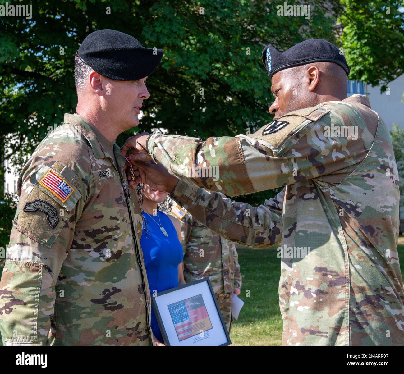 U.S. Army Maj. Gen. James M. Smith, commanding general (right) pins on the Legion of Merit medal ...