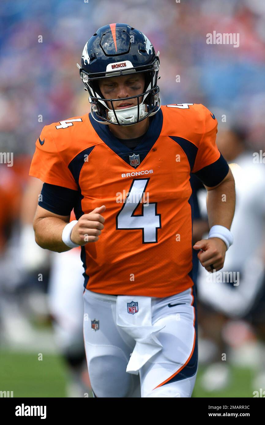 Denver Broncos quarterback Brett Rypien runs on the field during the ...