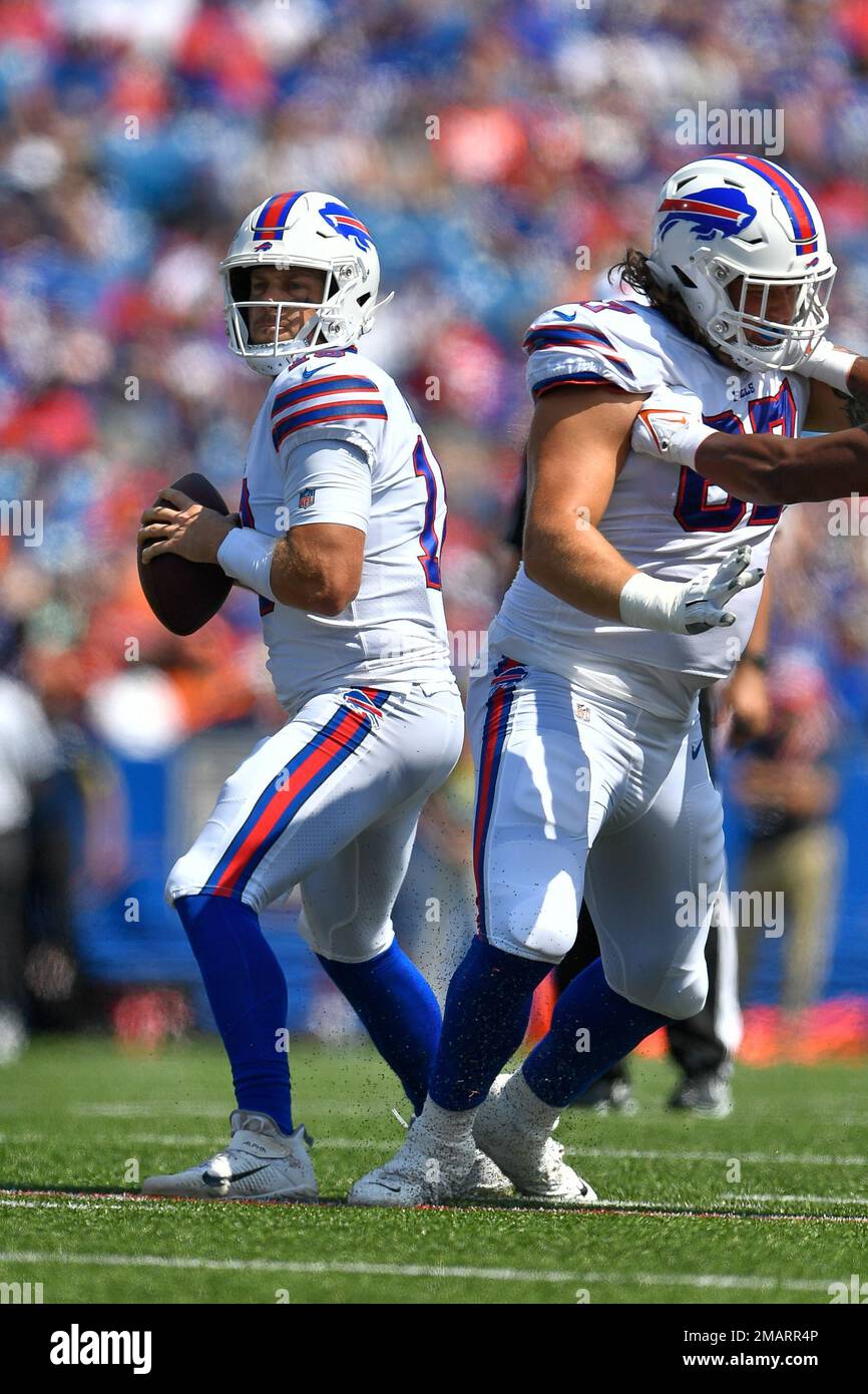 Buffalo Bills quarterback Case Keenum, left, looks to pass behind the ...