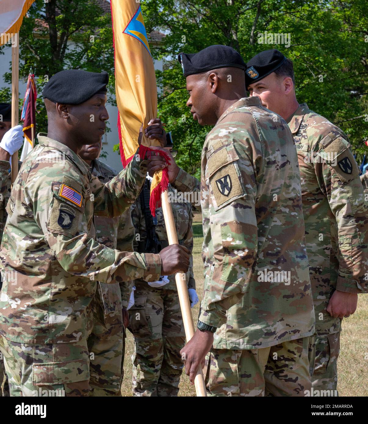 U.S. Army Maj. Gen. James M. Smith, commanding general (right) passes the unit colors to Command ...