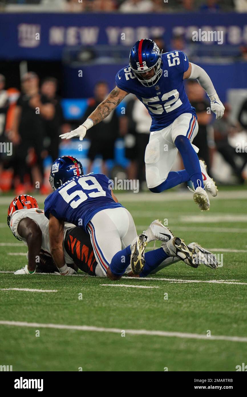 New York Giants linebacker Davis Webb (52) and linebacker Austin ...